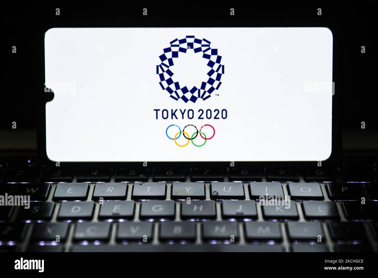 Tokyo 2020 Olympics logo is displayed on a mobile phone screen ...