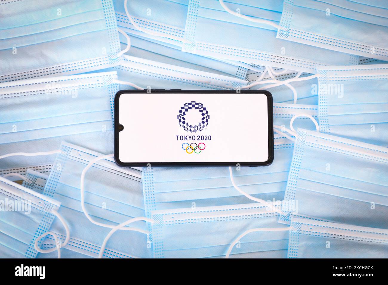 Tokyo 2020 Olympics logo is displayed on a mobile phone screen ...