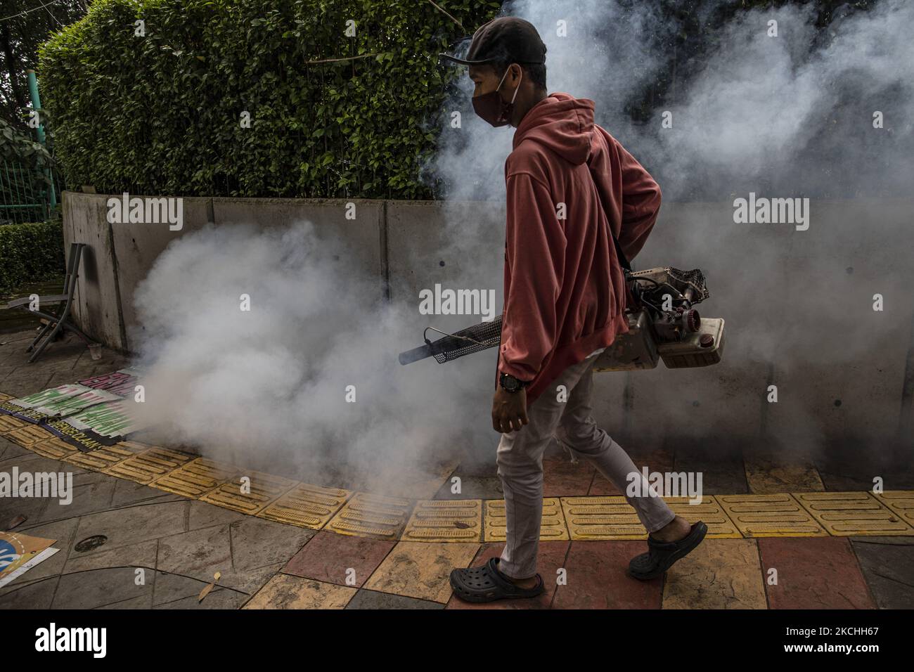 An officer conducts fogging in the BSD area, South Tangerang, Banten ...