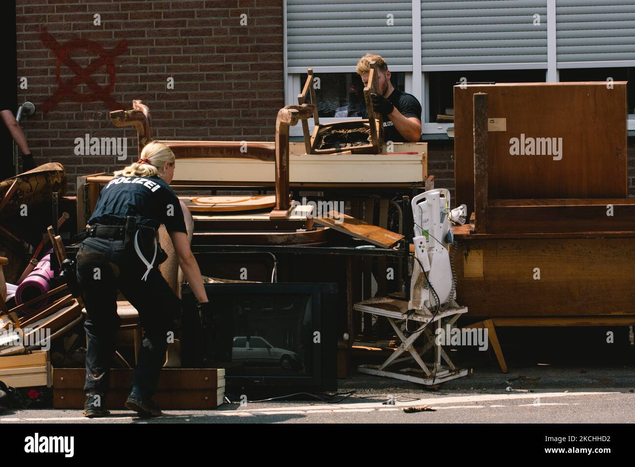 polices are seen moving the furniture with locals in Erftstadt, Germany ...