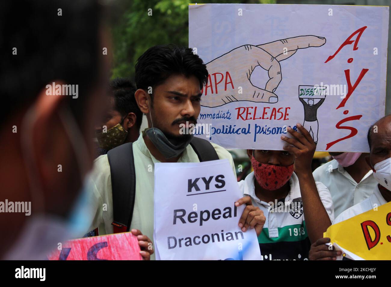 An activist holds a placard during a protest demanding justice for 84 ...