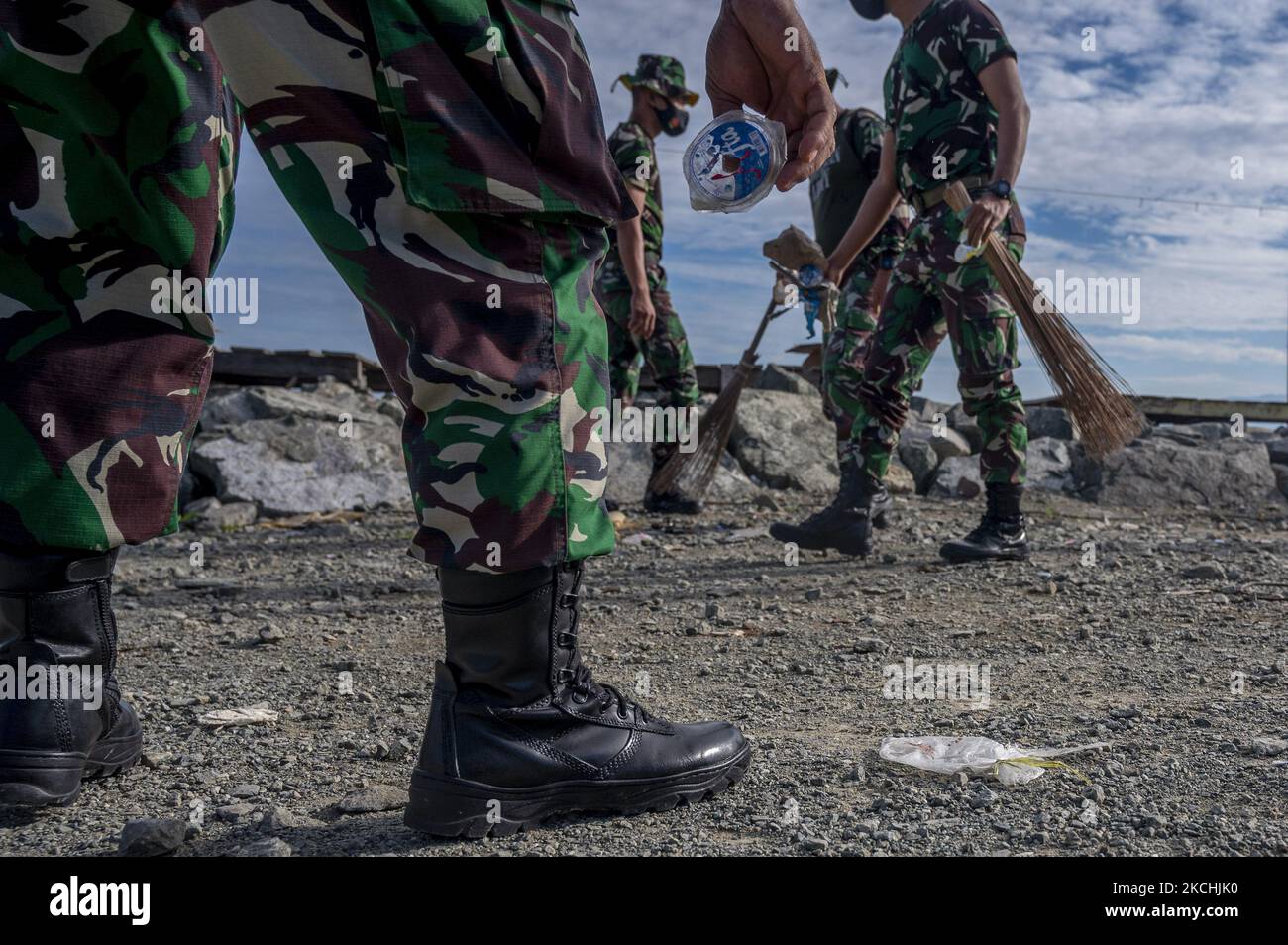 Indonesian Army soldiers pick up plastic waste scattered in the Talise ...