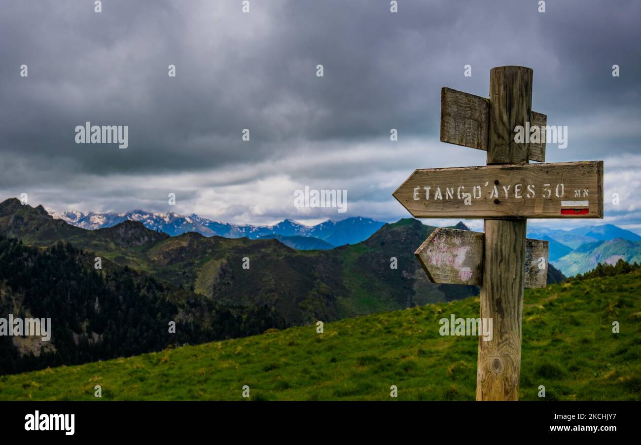 Trail indication signs with snowy mountains in the background near Ayes ...
