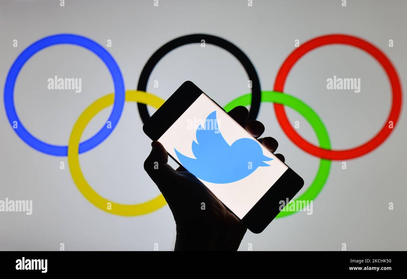 An illustrative image of the Twitter logo in front of Olympic Rings ...