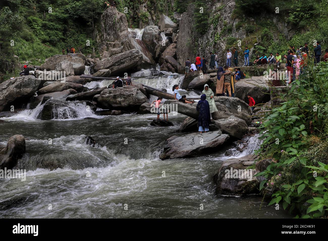 Local Tourists enjoy at Shrunz Waterfall on a hot day in Baramulla ...