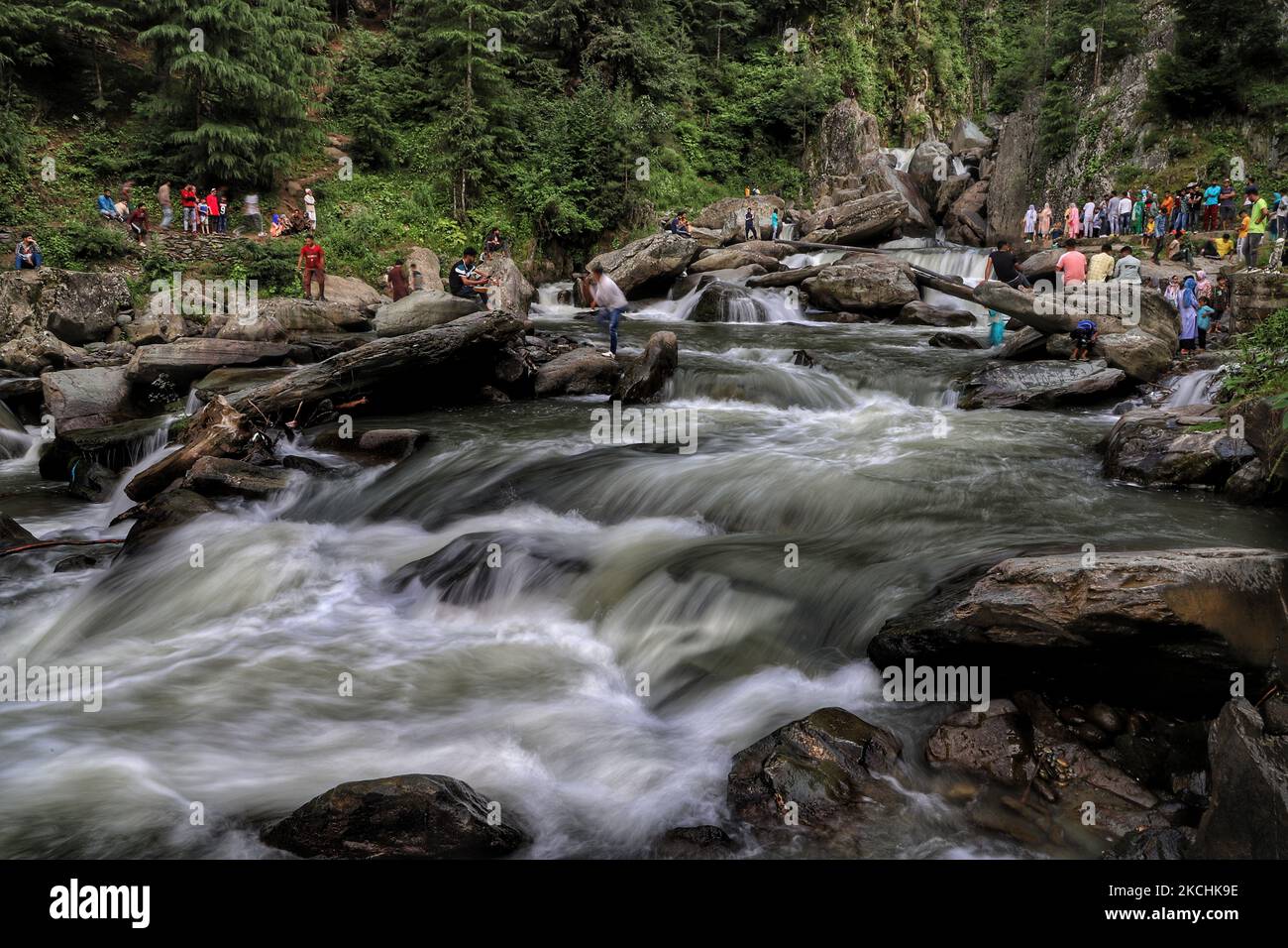 Local Tourists enjoy at Shrunz Waterfall on a hot day in Baramulla ...