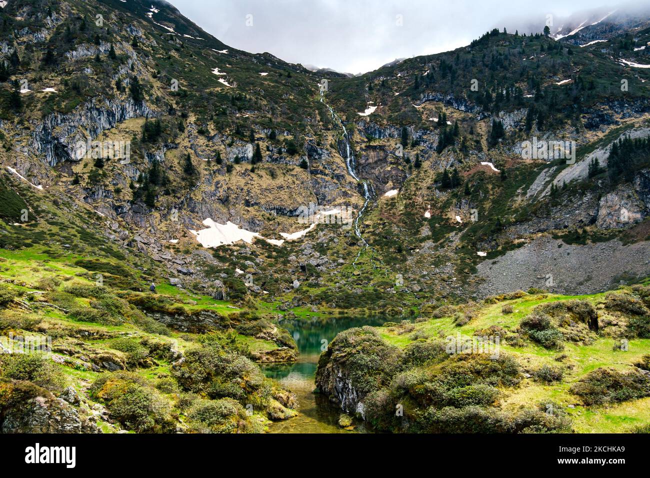 View on the beautiful blue lake of Ayes, with a waterfall, the pastures ...