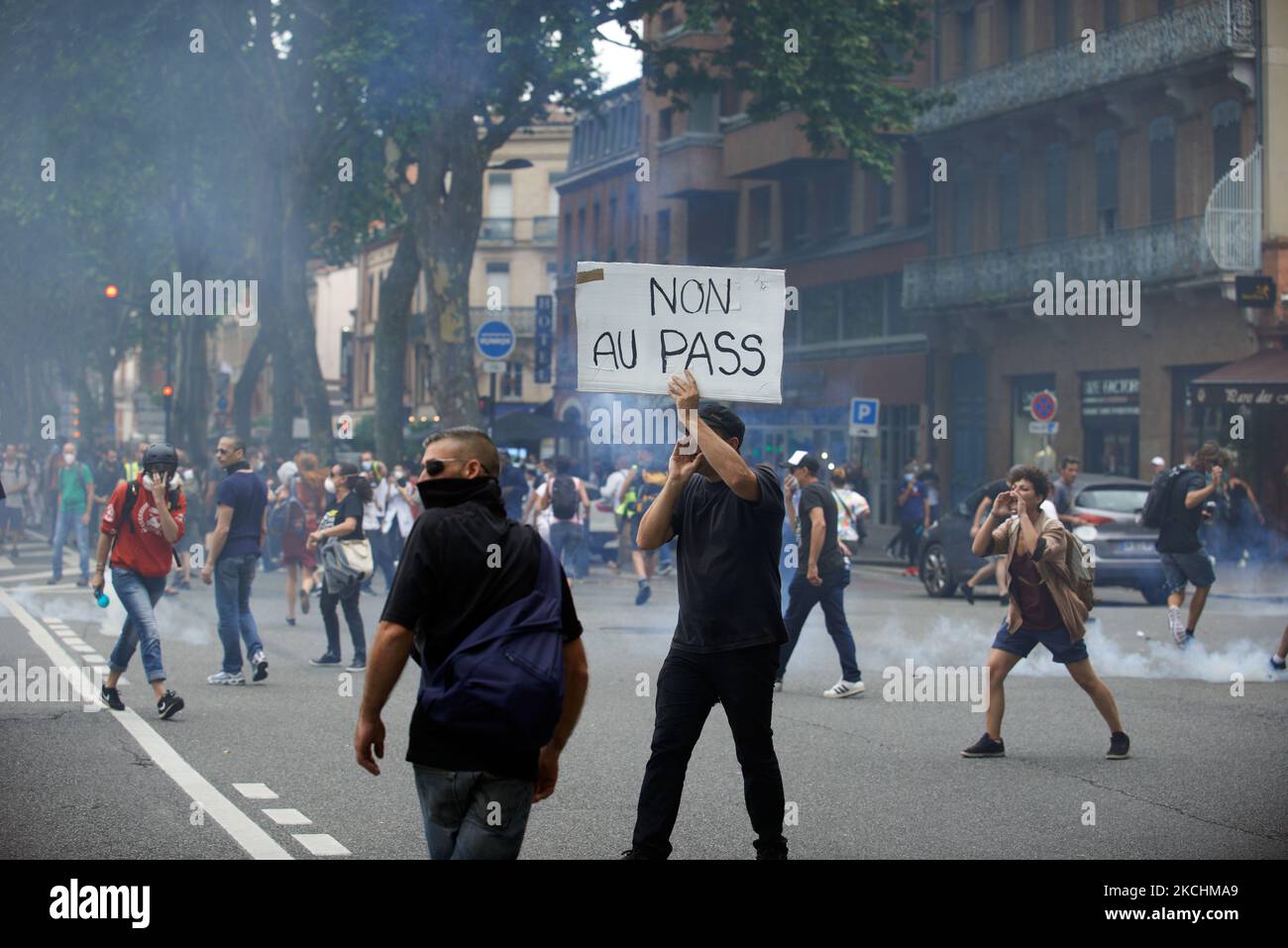 People shout towards riot police after they launched tear canisters in ...
