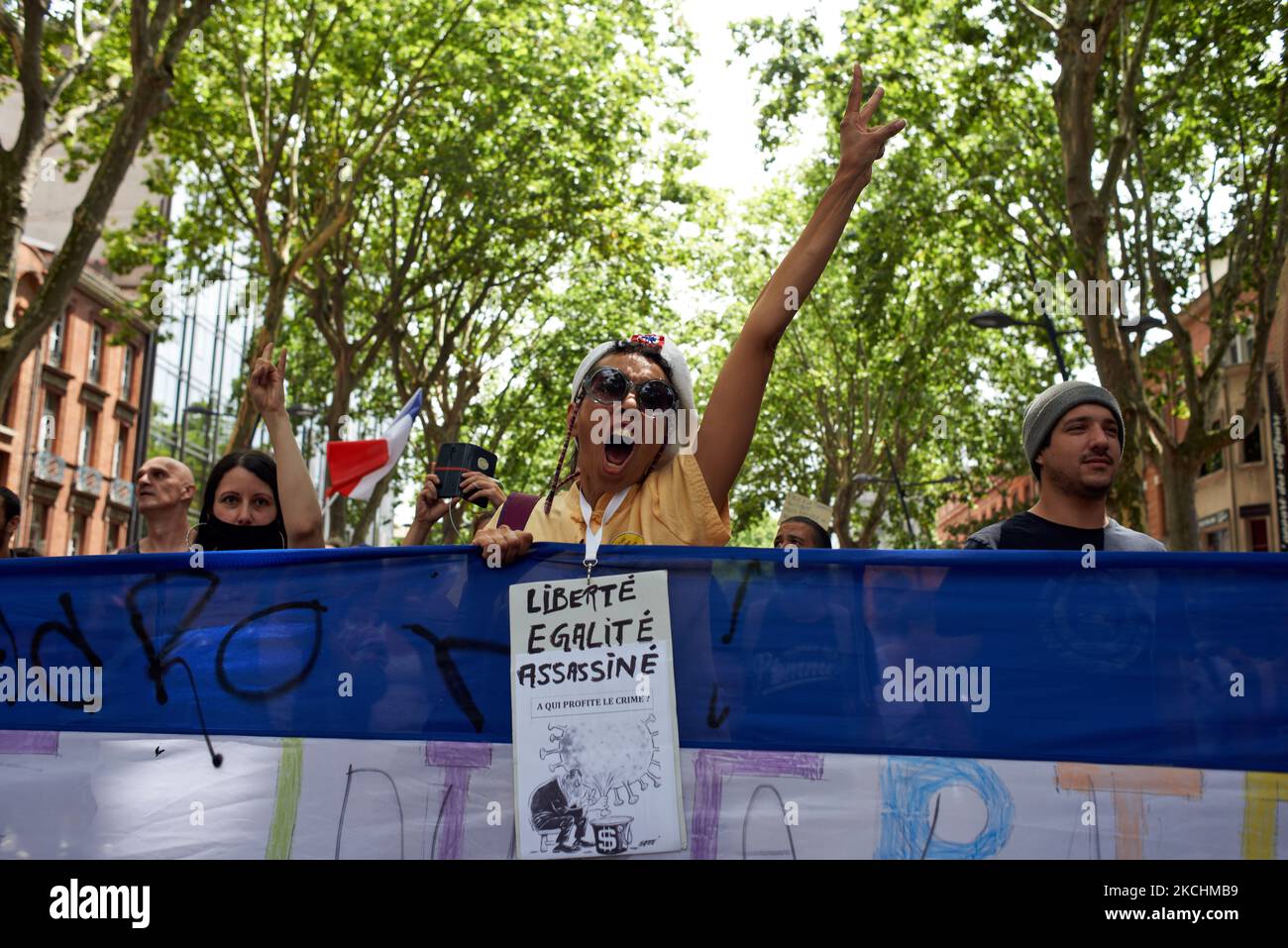 A woman reacts while holding a sheet 'Killed Liberty and Equality ...