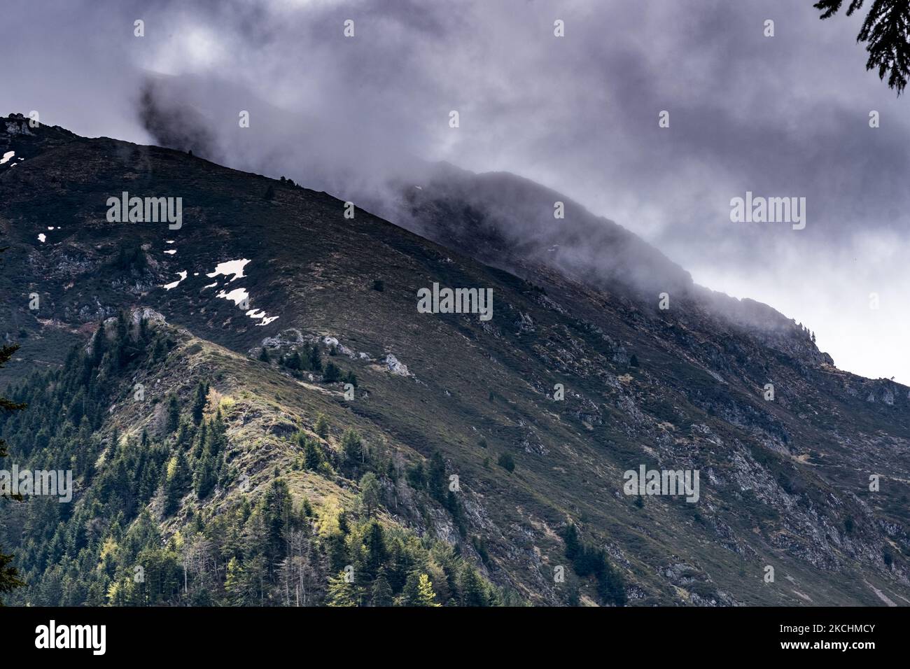 View on the mountains with a little bit of snow on a cloudy and moody ...