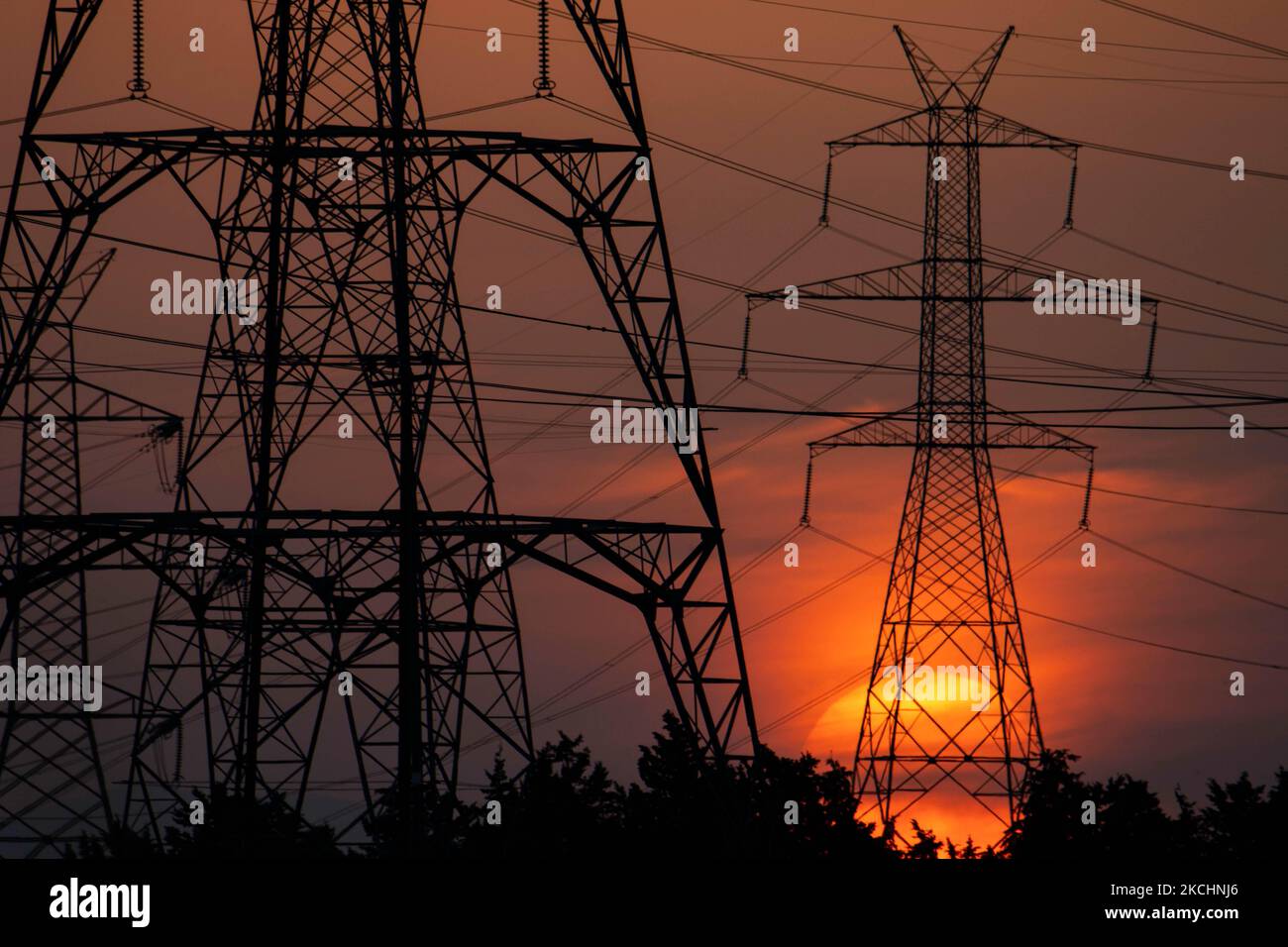 Silhouettes of powerlines and power poles hi-res stock photography and ...