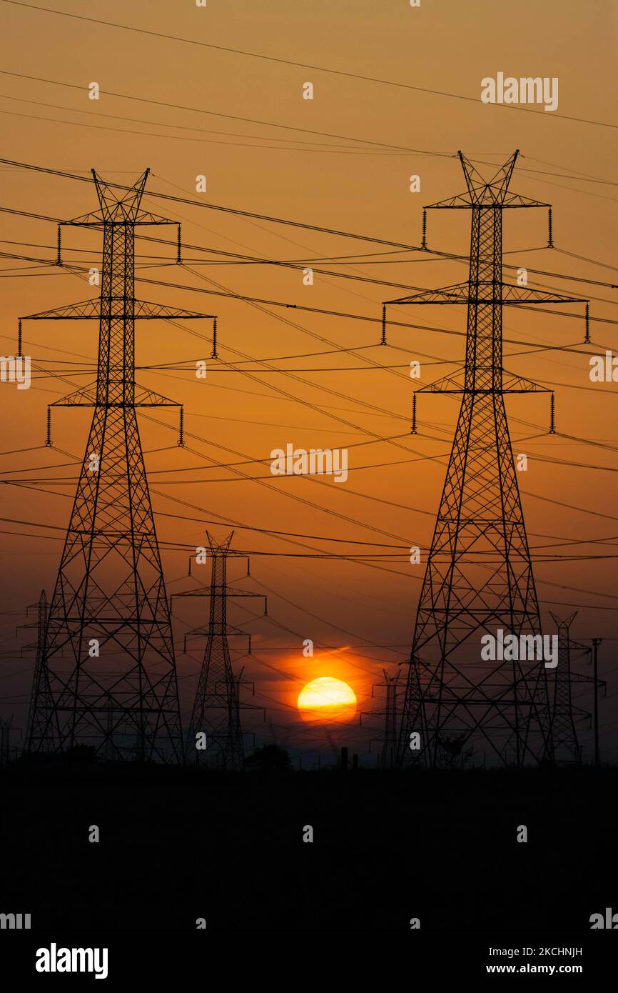 Summer sunset in Greece with electrical pylons near Thessaloniki city ...