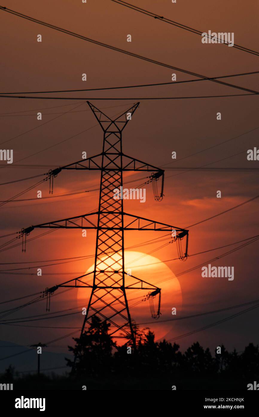 Summer sunset in Greece with electrical pylons near Thessaloniki city ...