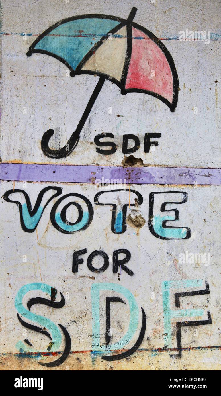 Political graffiti on the side of a building urging villagers to vote ...