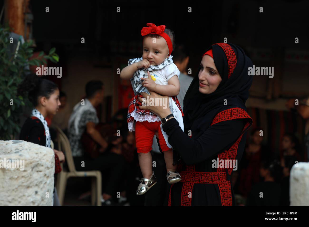 Palestinians participate in an event to mark the Palestinian ...