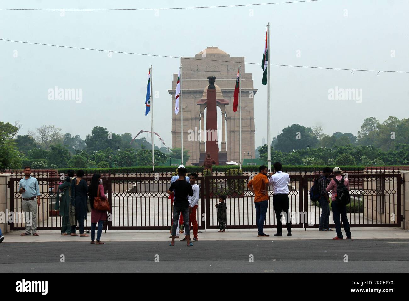 People click pictures at the India Gate War memorial, as they gather to ...