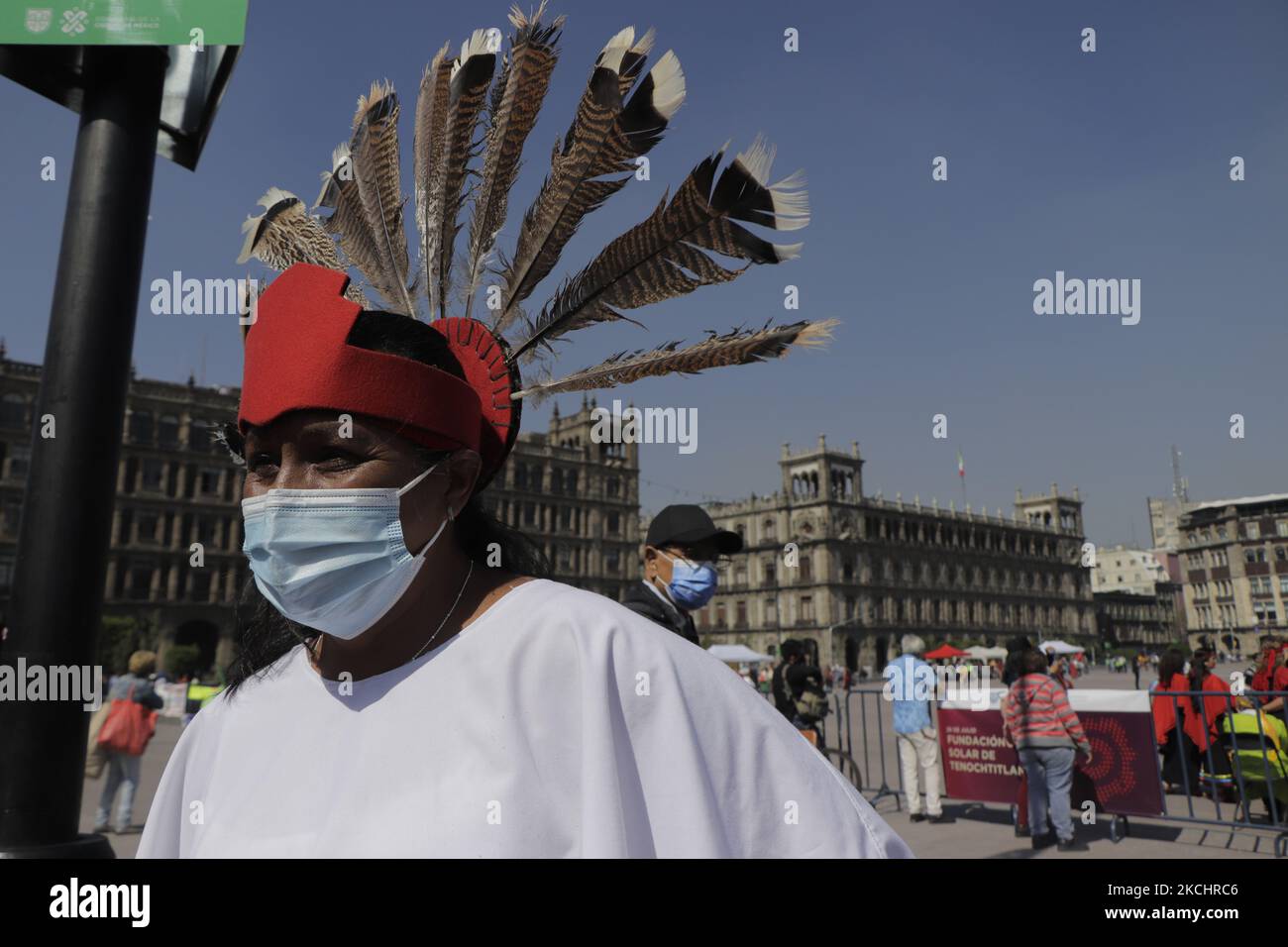 A pre-hispanic dancer carries a face mask during the celebration of the ...