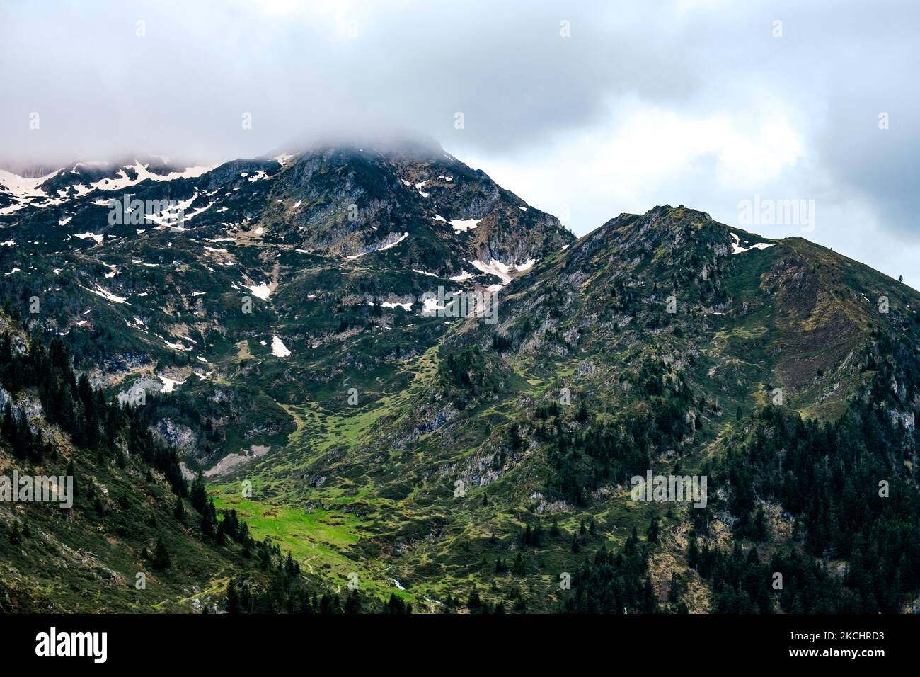 Clouds lingering on the peaks of the French Pyrenees mountains range ...