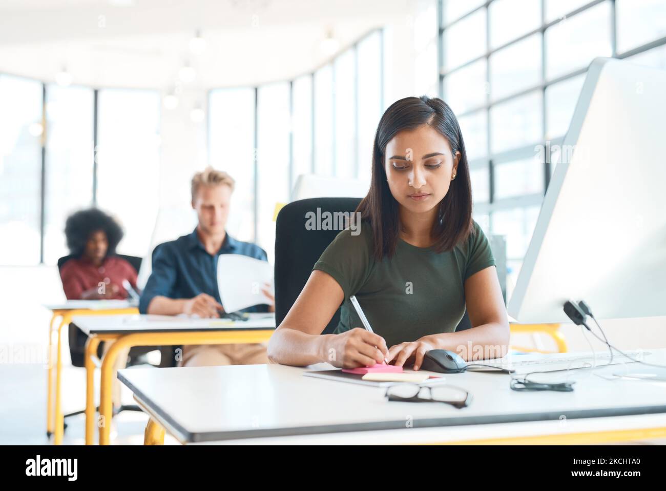 Leave the creative work to her. a group of creative designers hard at ...