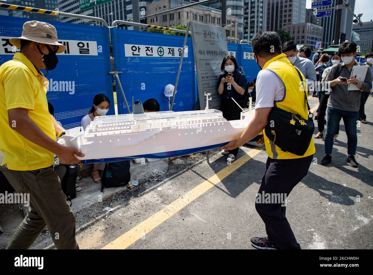 Members of the Sewol victims' council move the Sewol ferry model, which ...