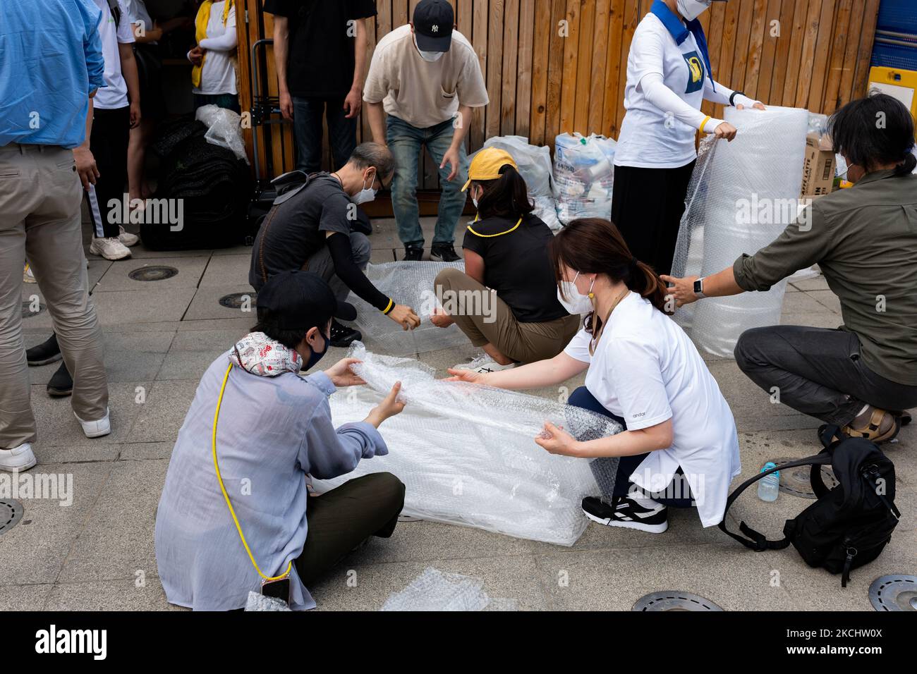 Members of the Sewol victims' council pack other art works, including ...