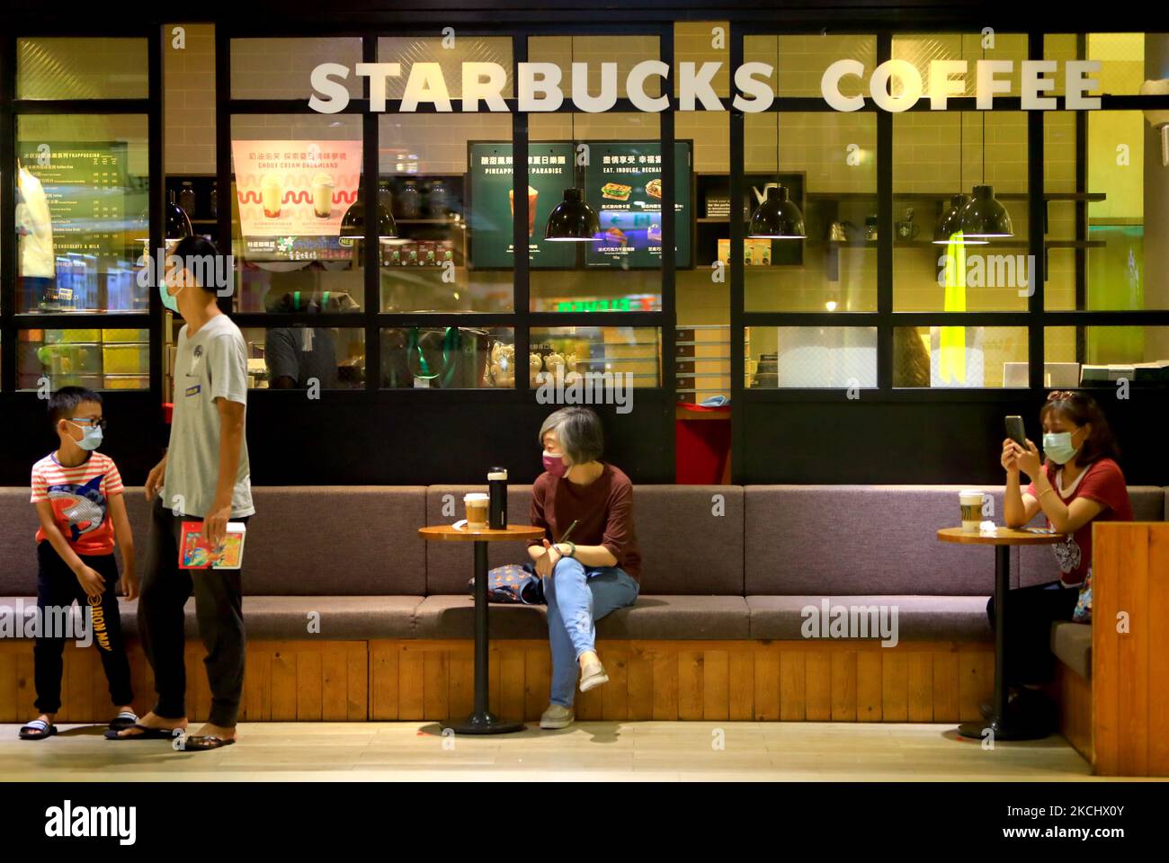 People drink coffee at a coffee shop in Taoyuan, as the nationwide ...