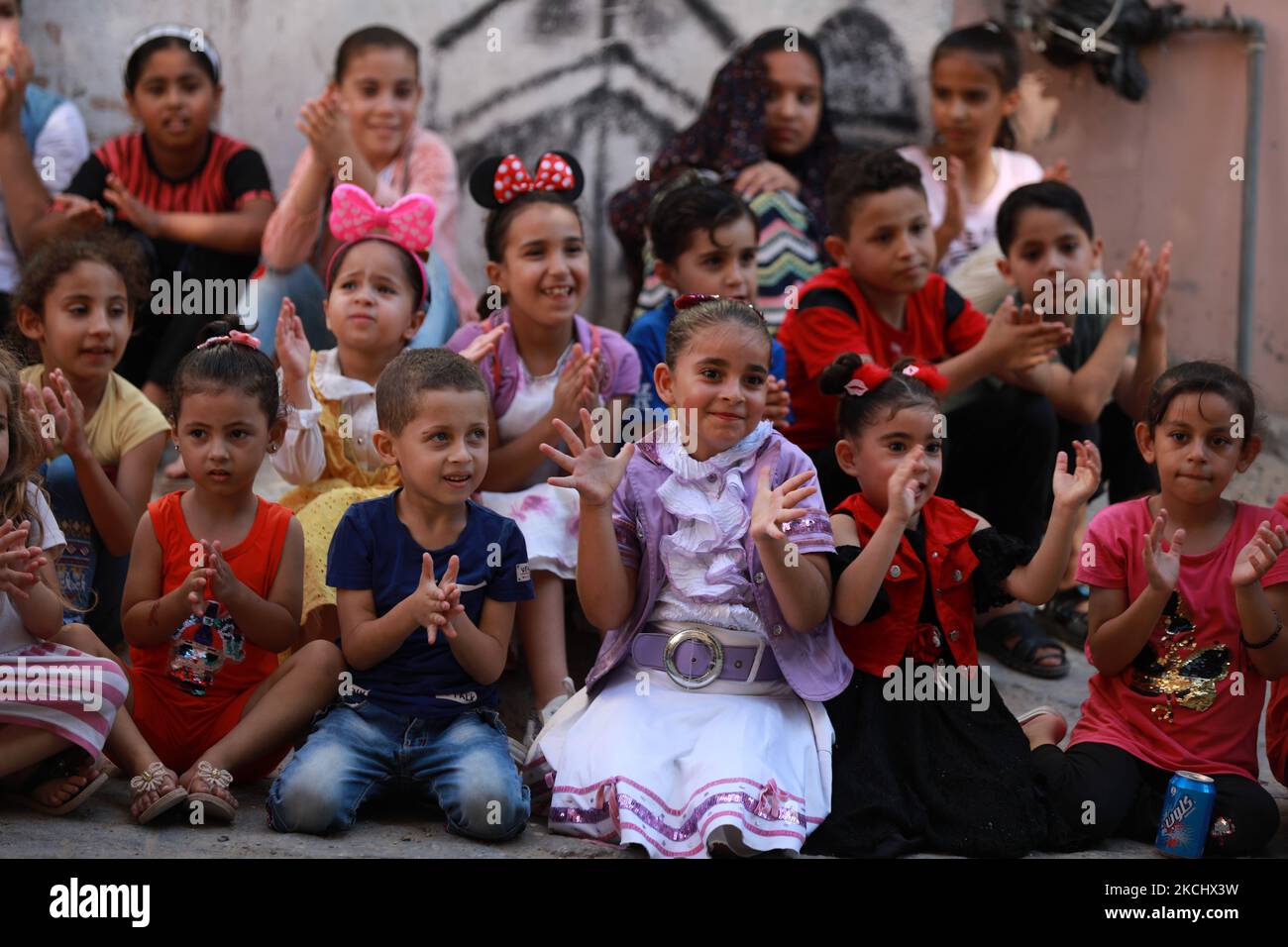 Palestinian children dance and cheer as musicians of the Edward Said ...