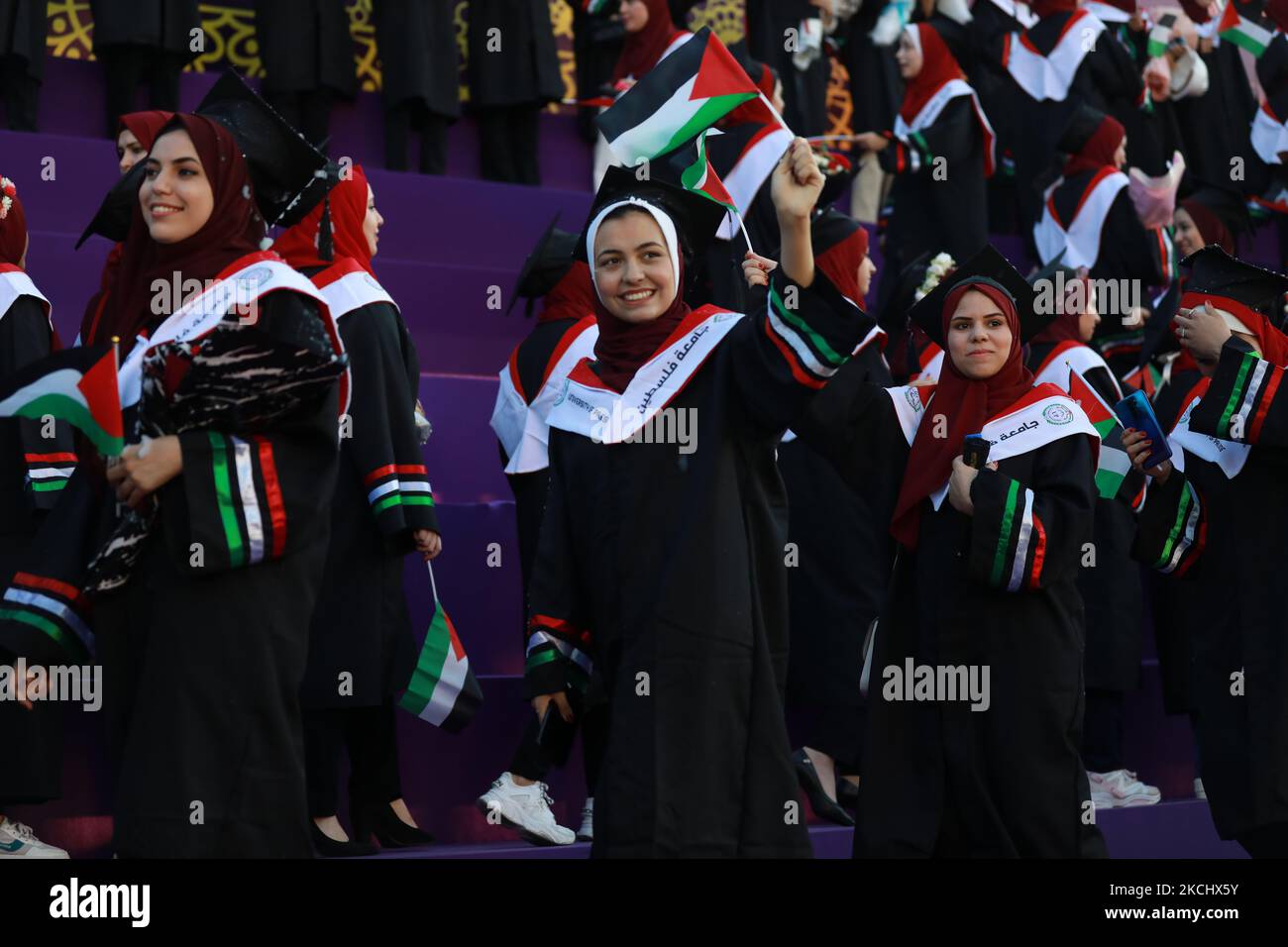 Palestinian female students attend their graduation ceremony at ...