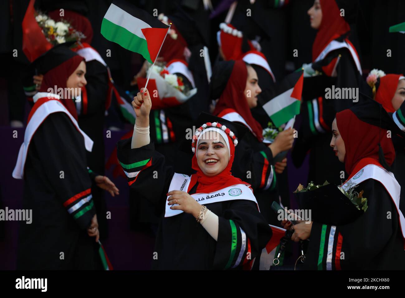 Palestinian female students attend their graduation ceremony at ...