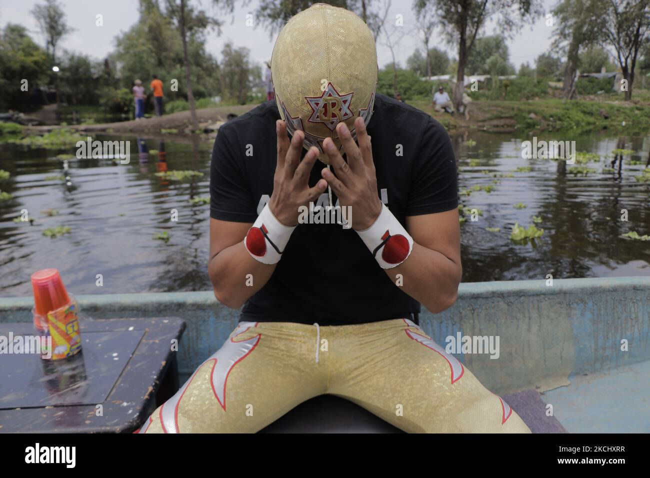 Gran Felipe Jr., a professional wrestler, aboard a boat as he adjusts ...