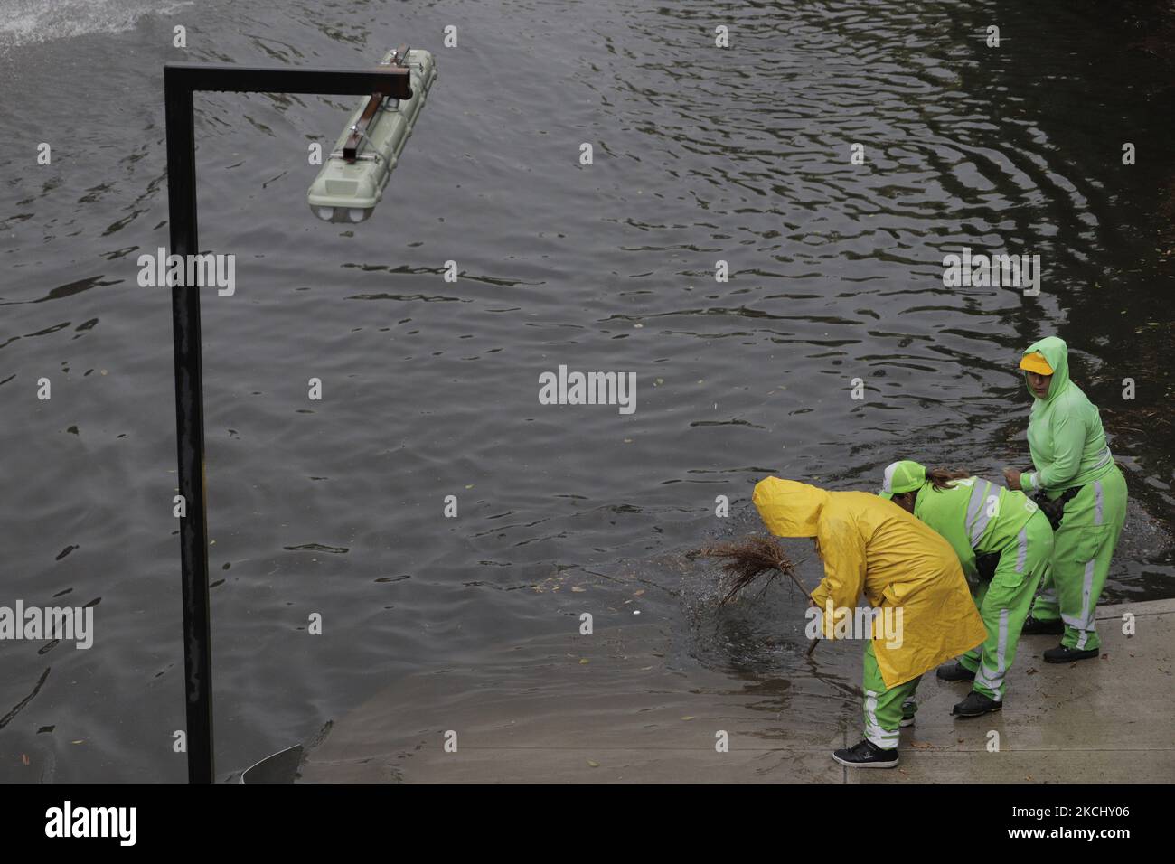 Cleaning workers uncover drains under heavy rain in Mexico City where ...