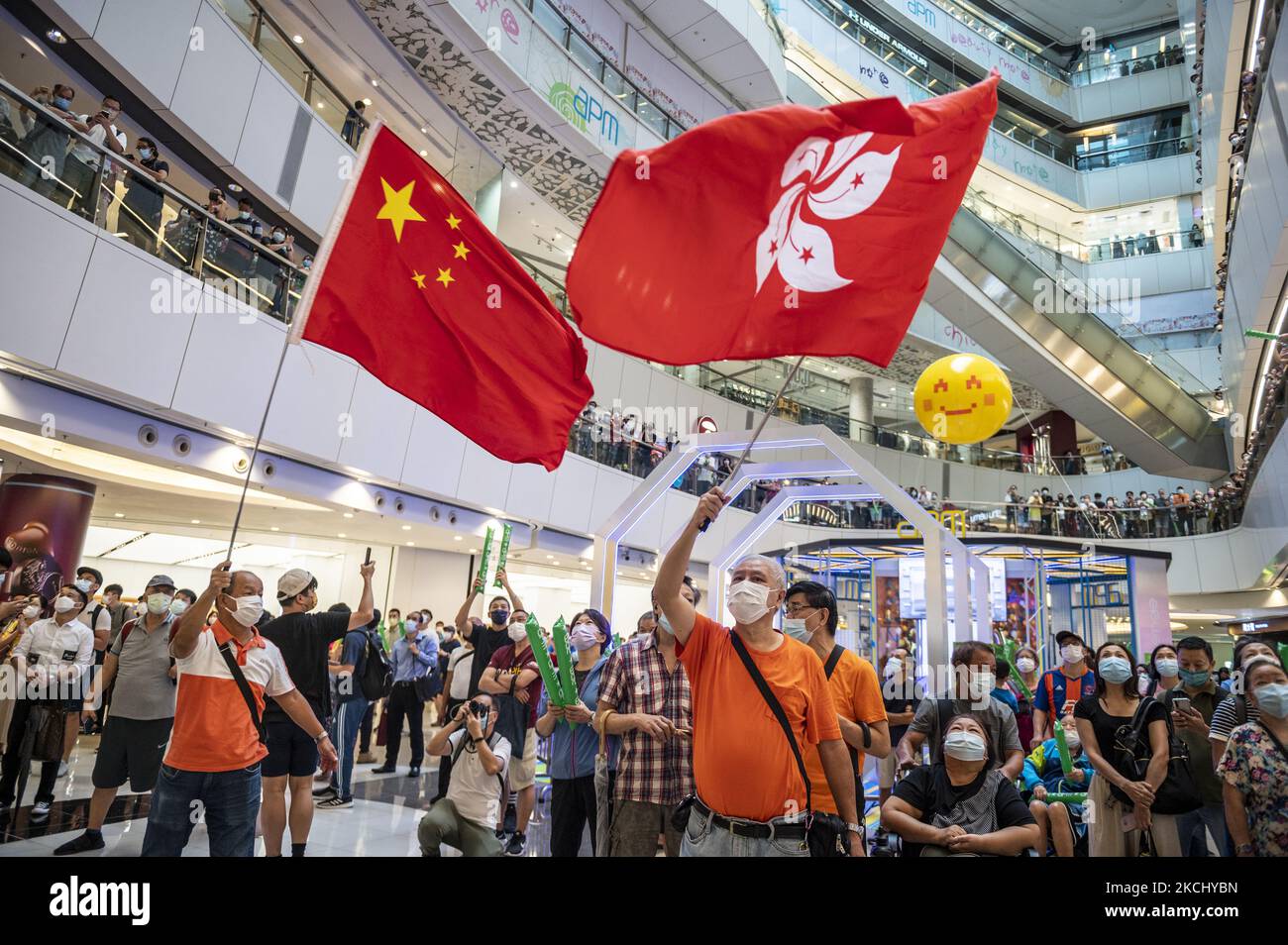 Two man waves the China National flag and the Hong Kong SAR flag as ...