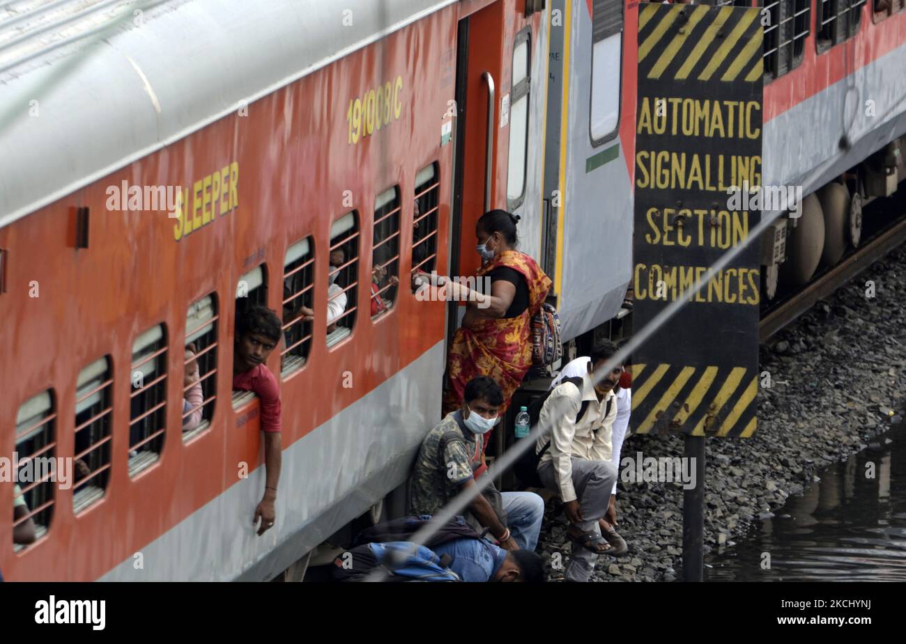 Long distance train passengers deboard a stranded train due to heavy ...