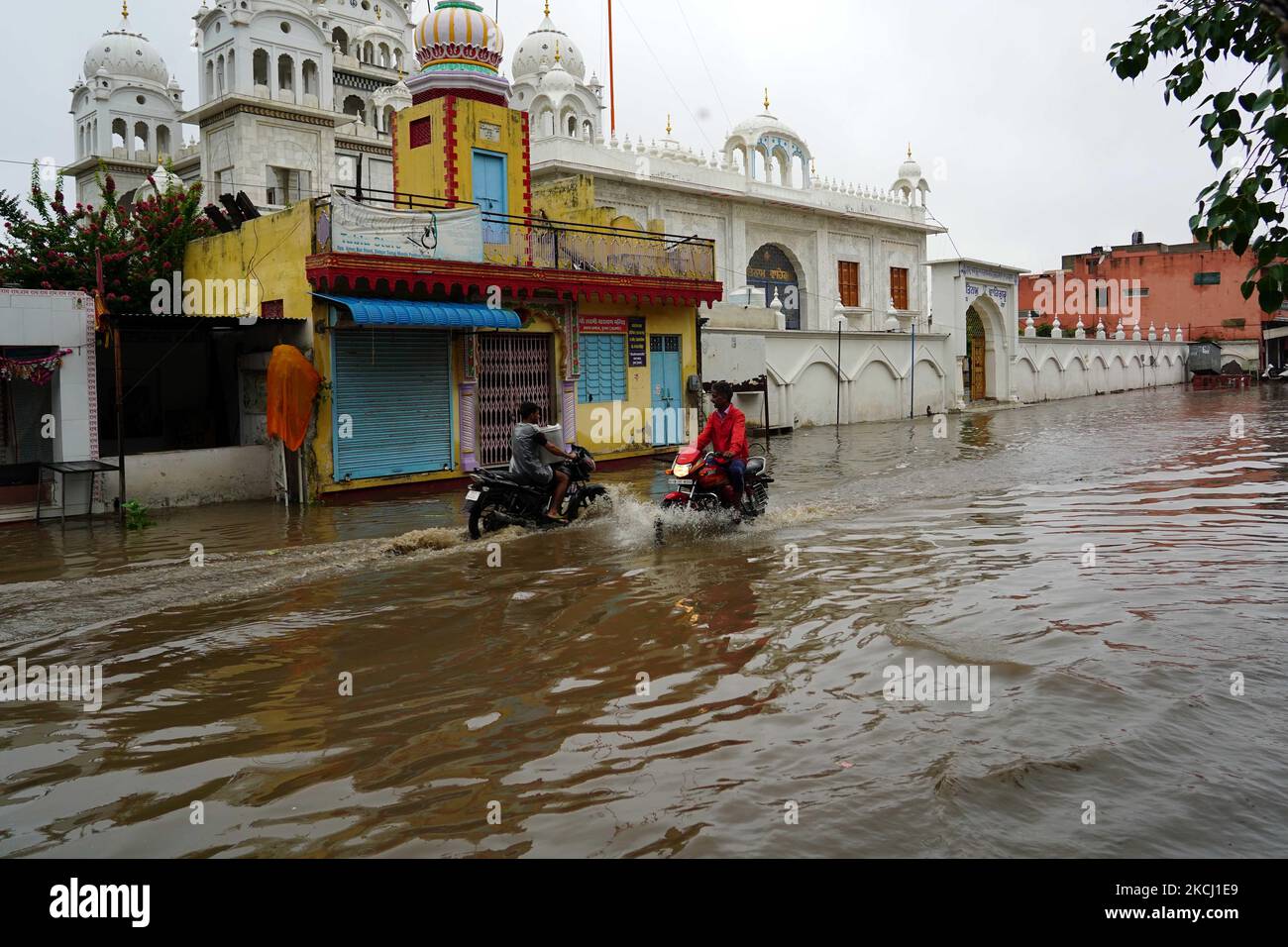 Indian People cross a Flooded street after heavy Monsoon Rains in ...