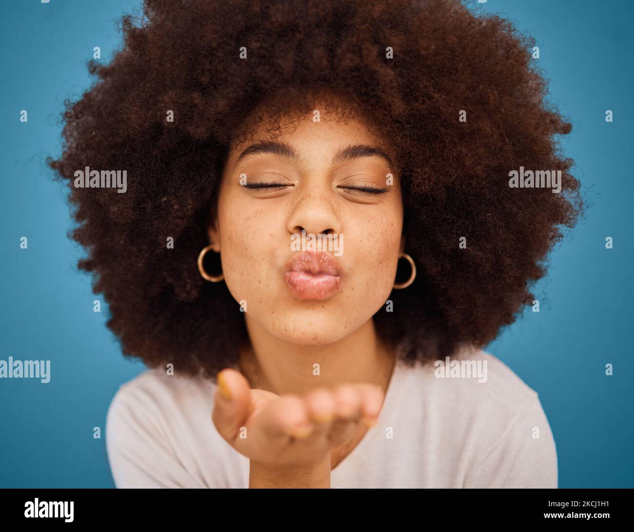 Care, love and black woman blowing kiss with a smile, afro hair and ...
