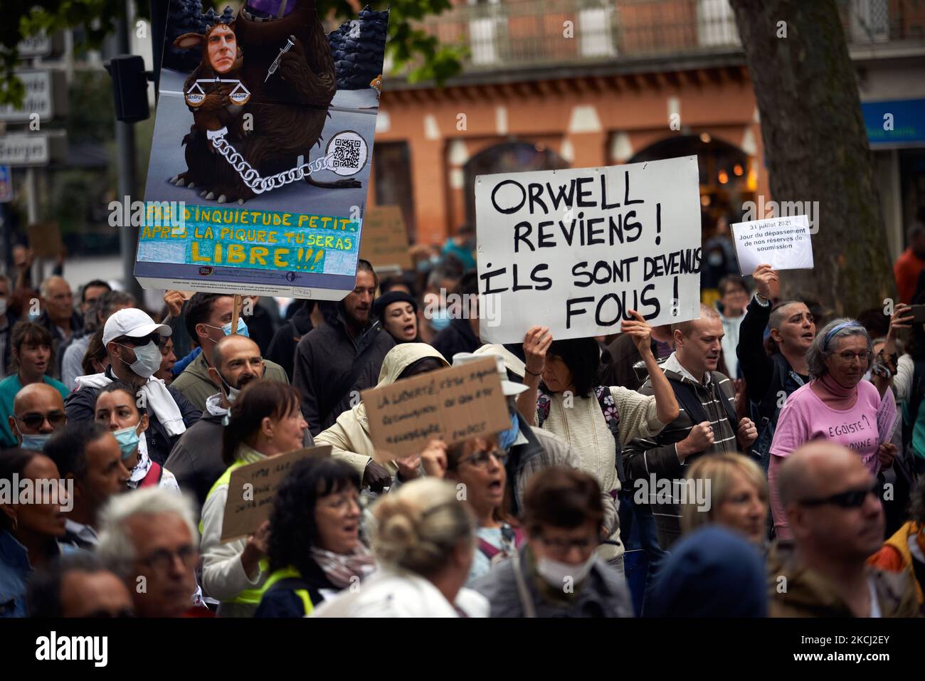 A protester holds a placard reading 'Orwell, come back, they're gone ...