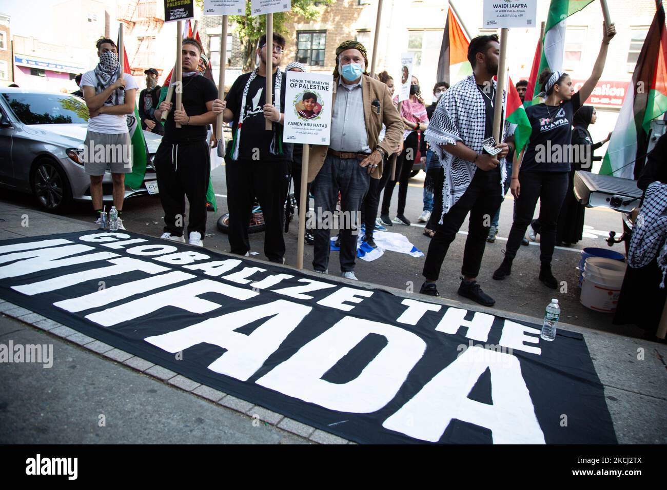 A sign reading ''Globalize The Intifada'' is seen on the ground as ...