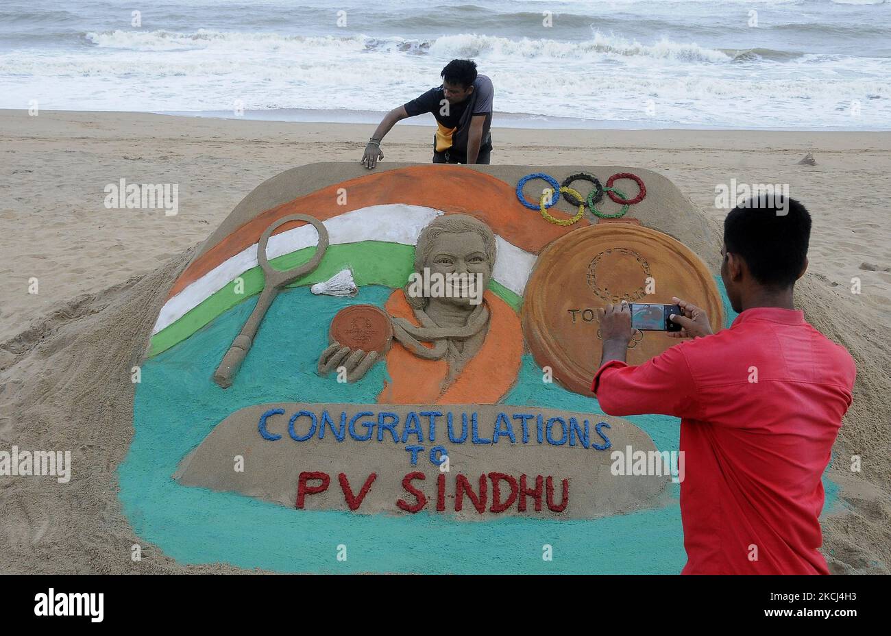 Sand artist Manas Sahoo creates a sand sculpture to congratulate P.V ...