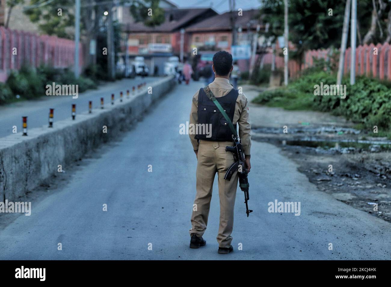 A Jammu and Kashmir Police Cop (JKP) stops public movement after ...