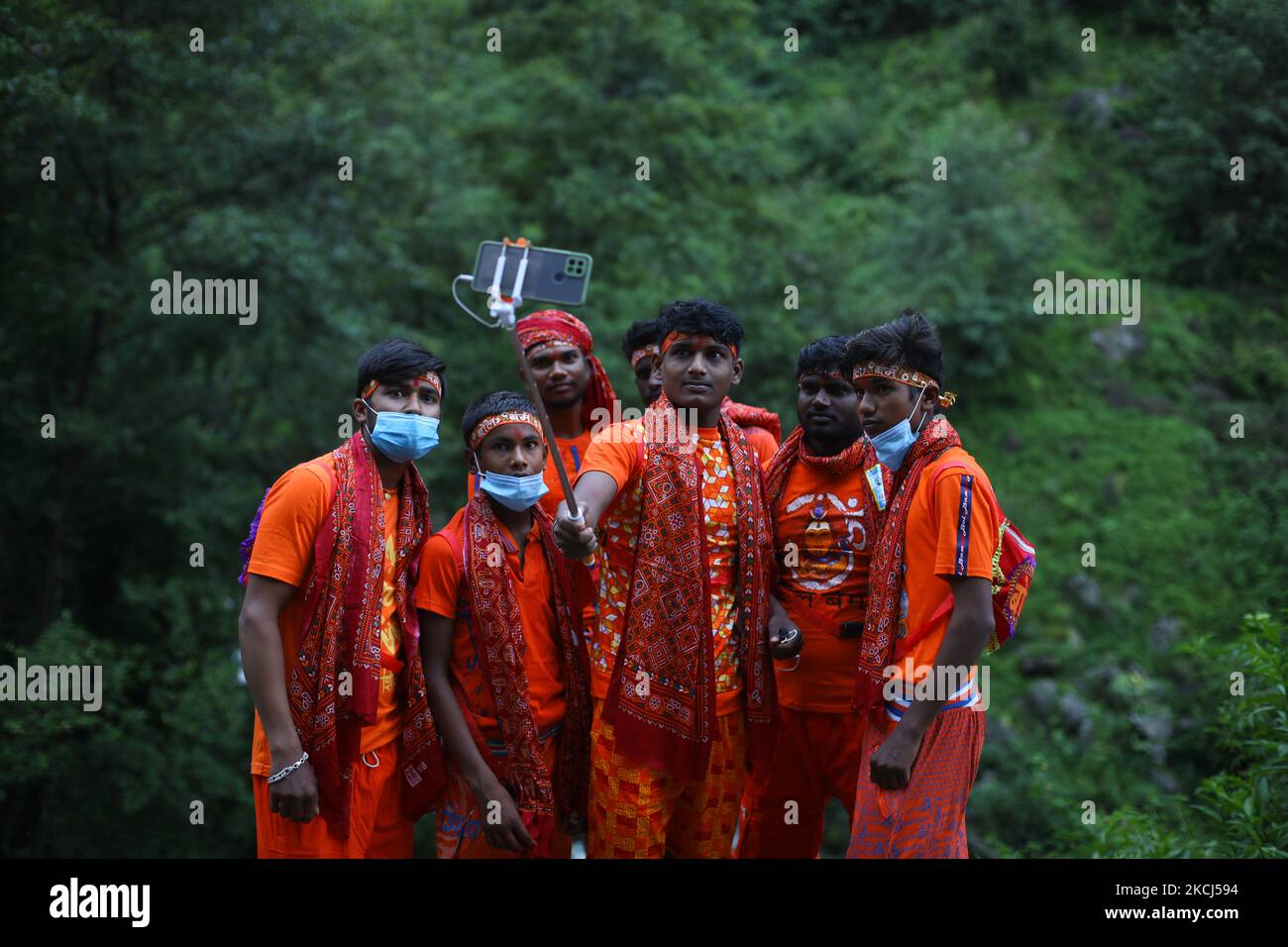 A Hindu worshipper or pilgrim also called Bol Bom offer prayers as he ...