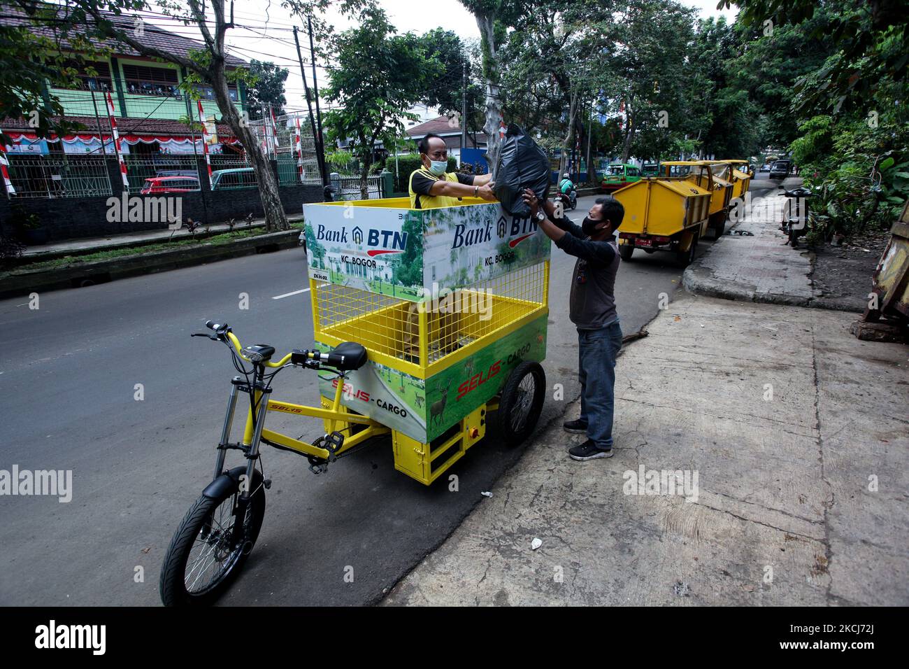 A Man throw rubbish non-organic into a eco-friendly electric bicycle ...