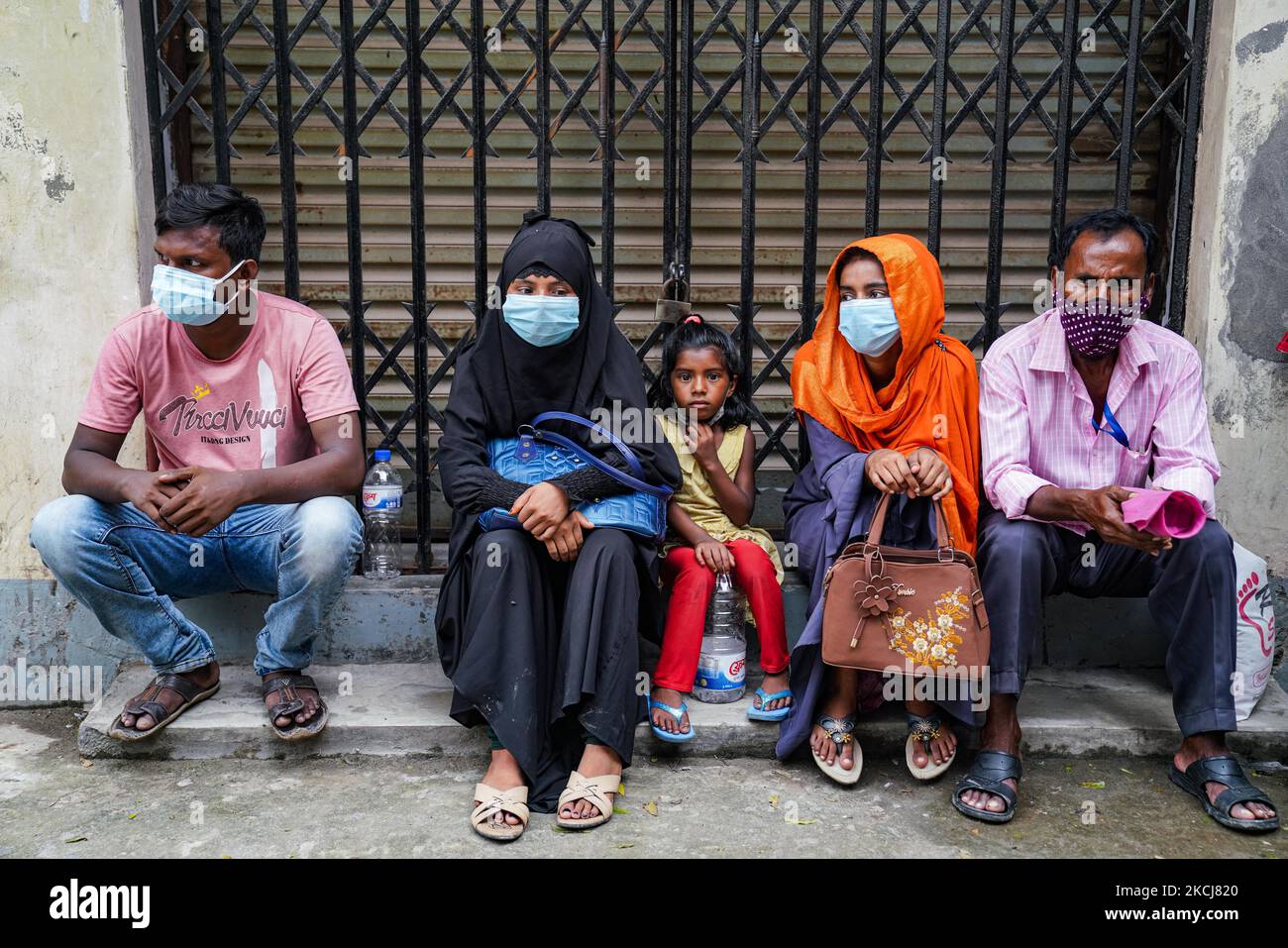 Relatives wait to receive the dead bodies of factory fire victims at a ...