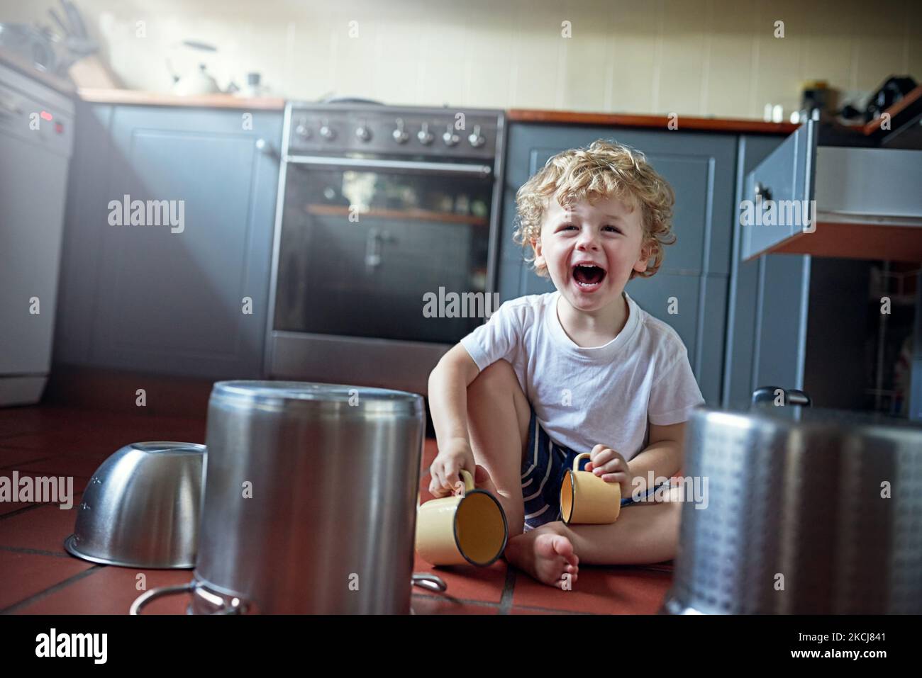Noise is the sound of fun for kids. Portrait of an adorable little boy ...