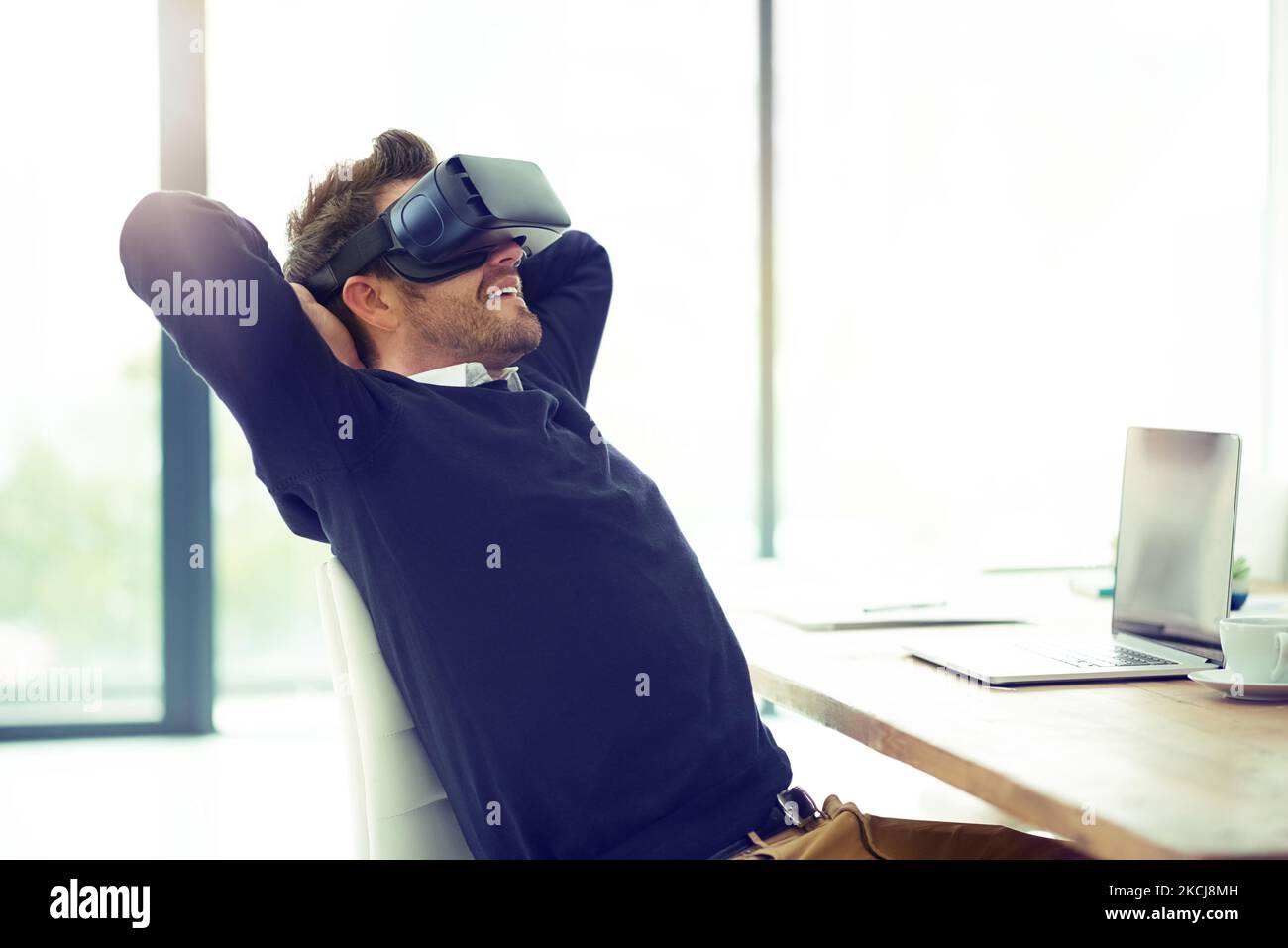 Business and relaxation done in one. a businessman wearing a VR headset ...