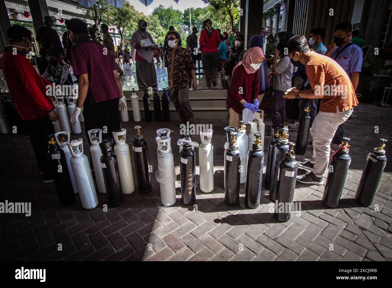 A queue of oxygen cylinders to be refilled for free for residents at ...