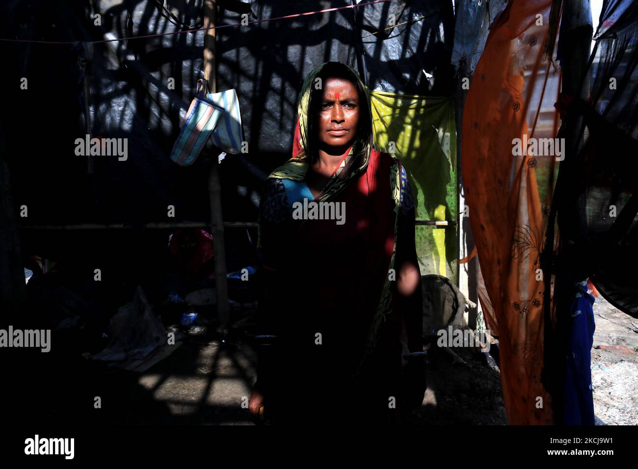 An Indian villager assesses damage in homes following floods in the ...