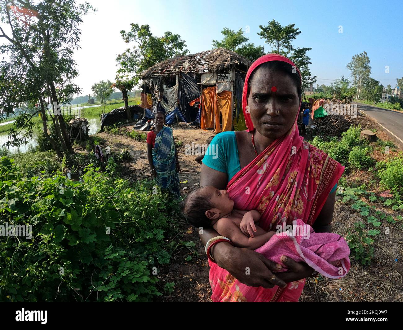 An Indian villager assesses damage in homes following floods in the ...