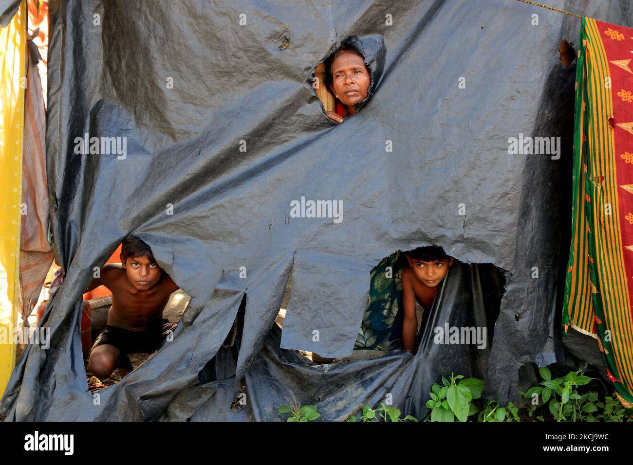In this picture taken on August 05, 2021, Indian residents sit next to ...