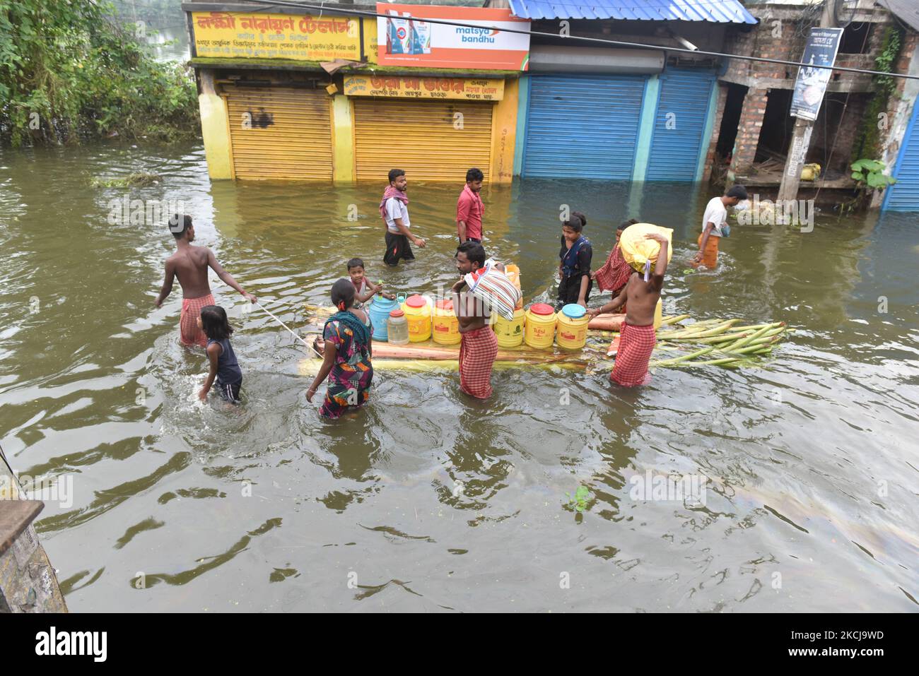 Villagers use temporary boats made of banana trees to carry drinking ...