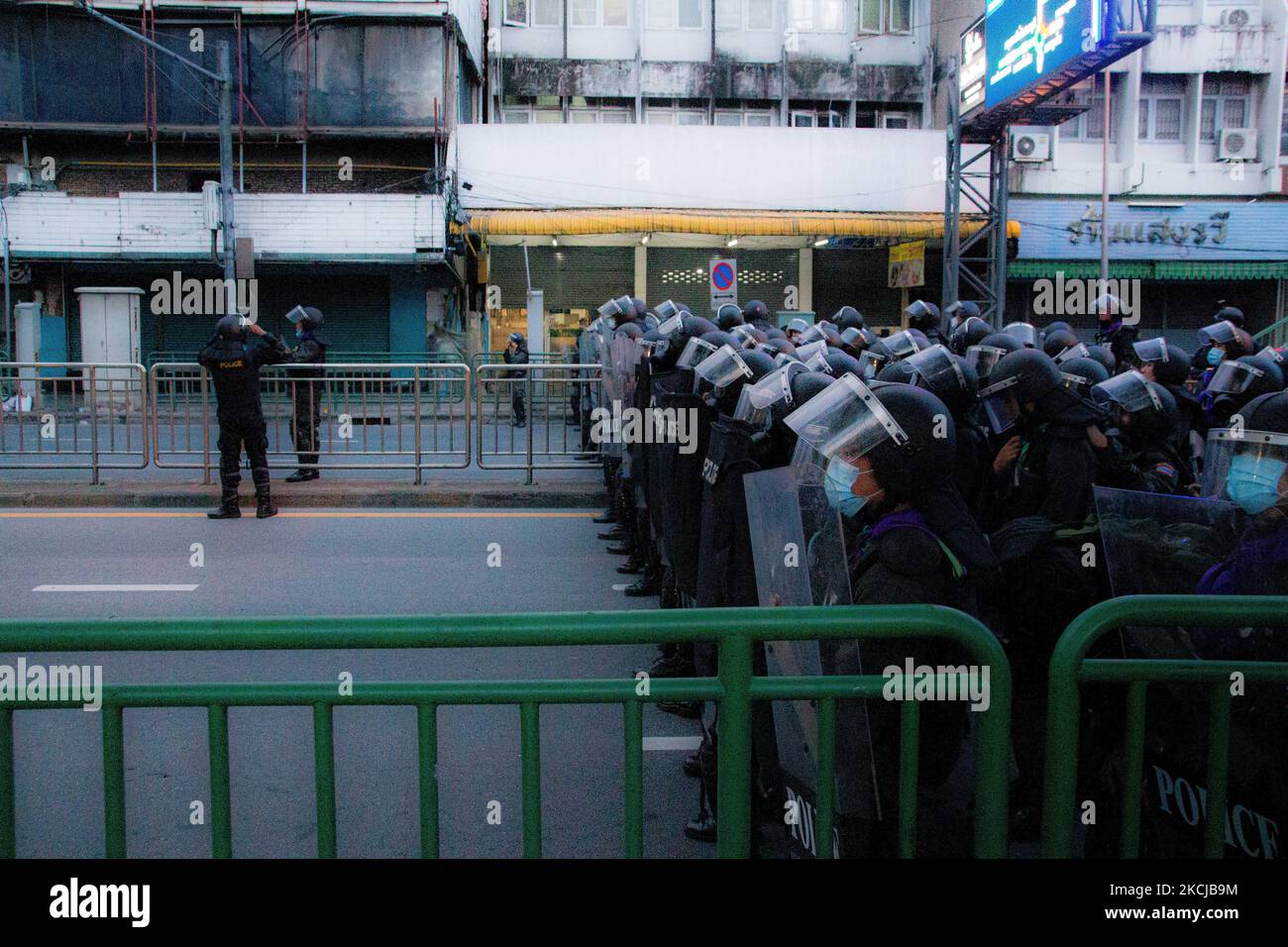 Thai riot police in a standoff with anti-government protesters in ...